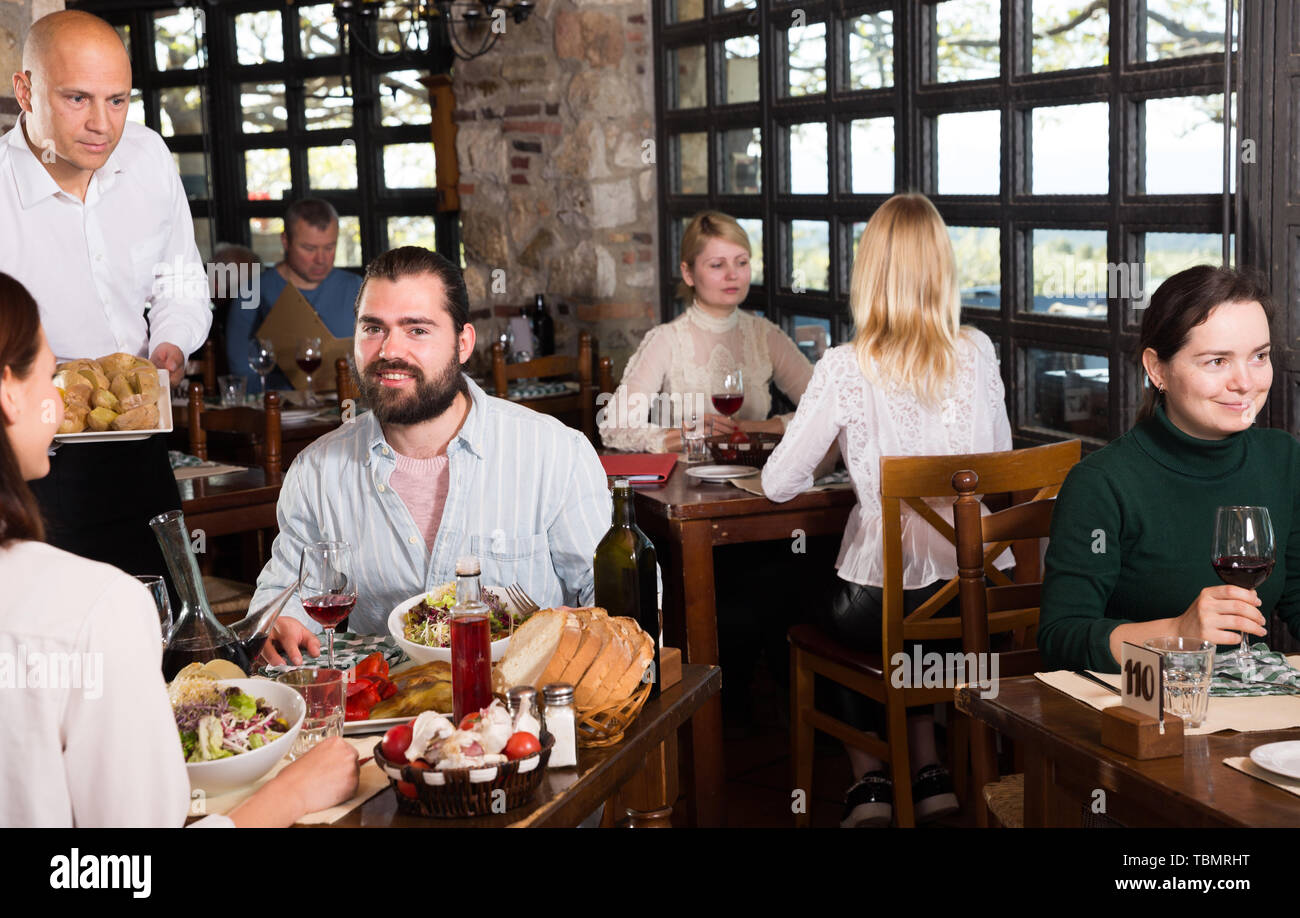 Charming atmosphere of cozy rustic restaurant with relaxed diners ...