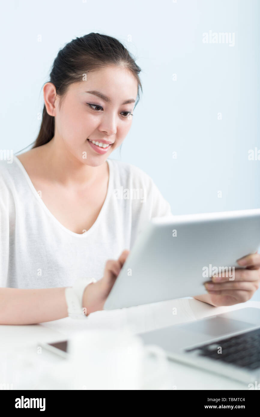 young pretty chinese woman working with laptop in office Stock Photo ...