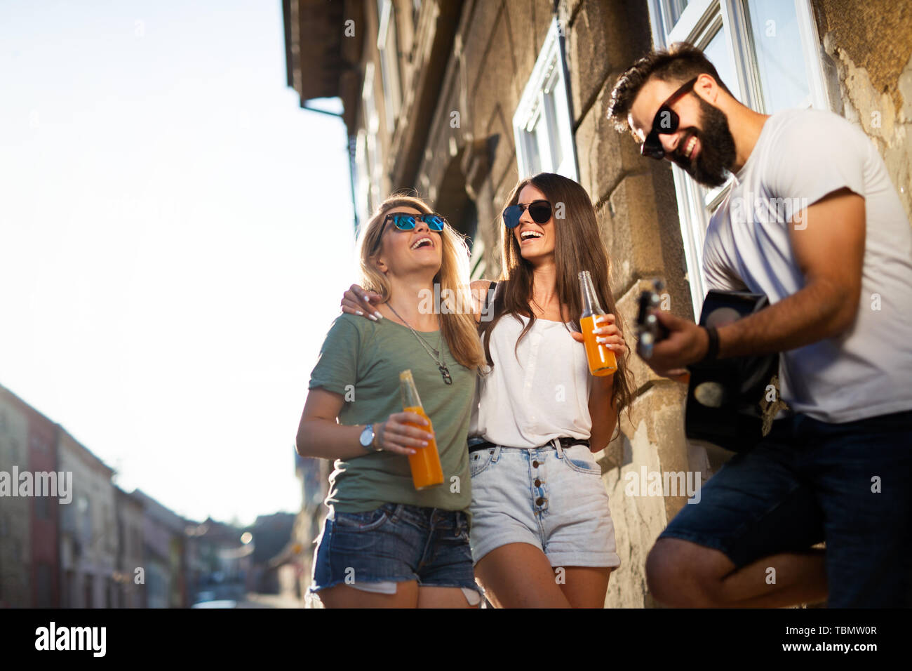 Group of young people smiling, talking and having fun together Stock ...