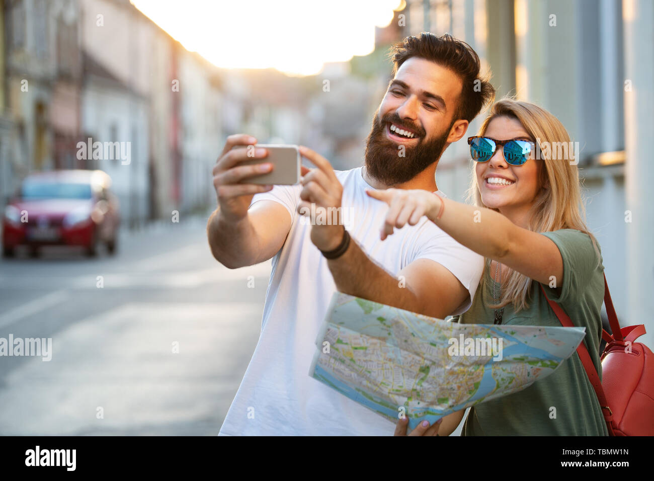 Traveling couple of tourists walking around old town. Vacation, summer ...
