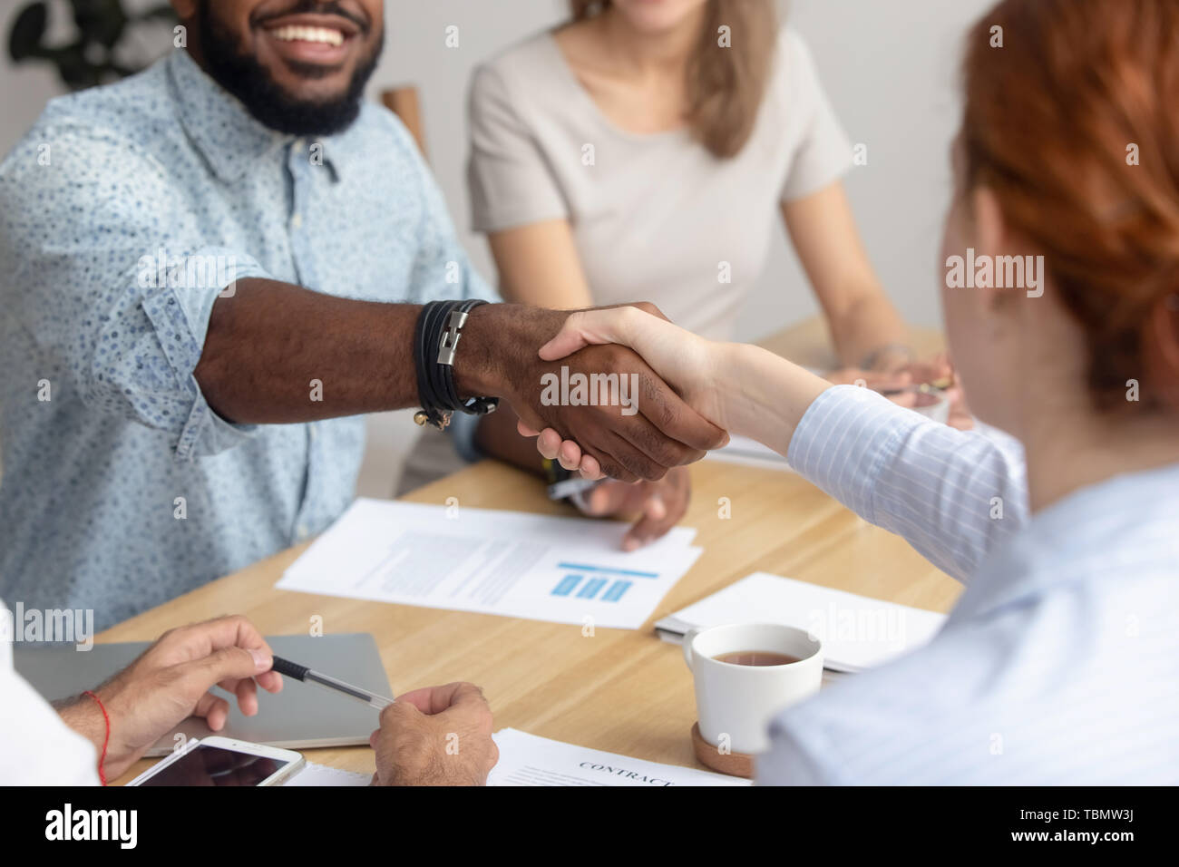 Close up male and female diverse business people handshake Stock Photo ...