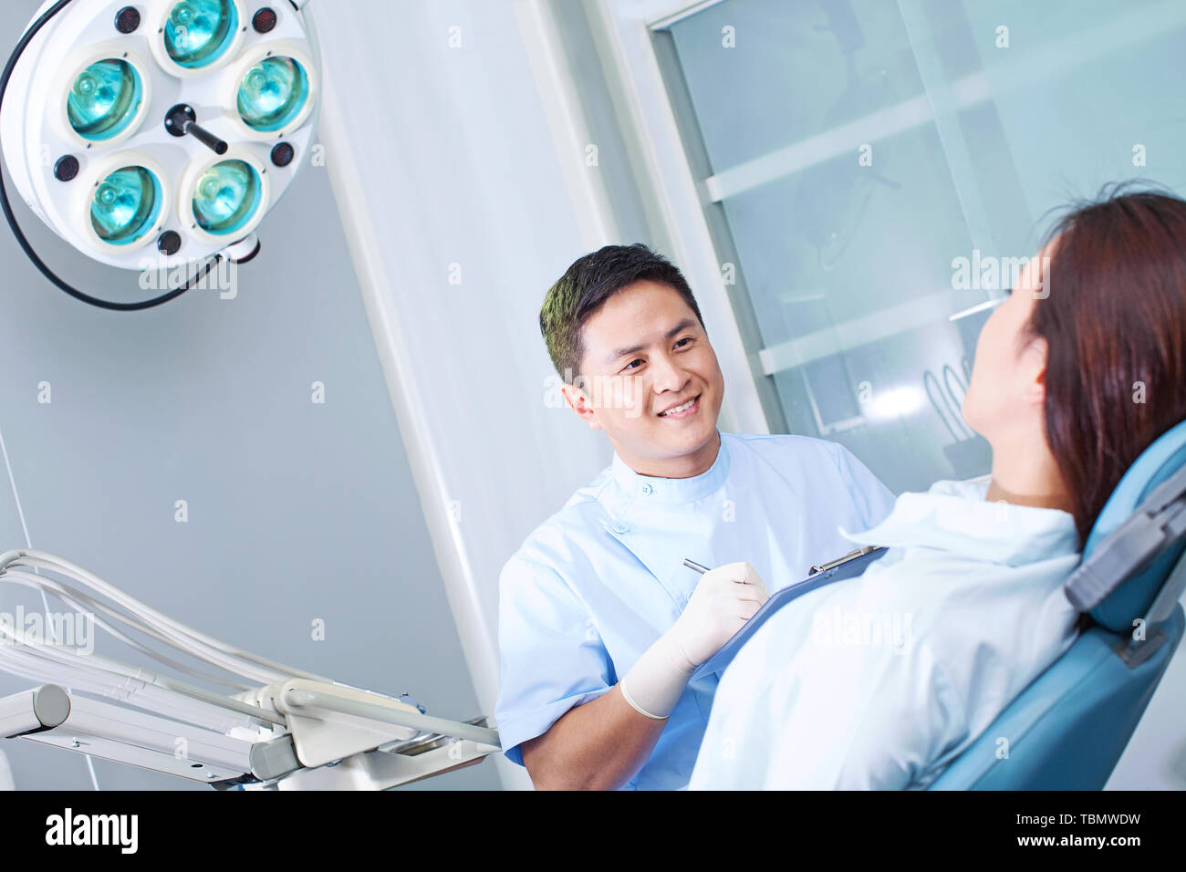 Doctors treat teeth with patients in clinic Stock Photo - Alamy