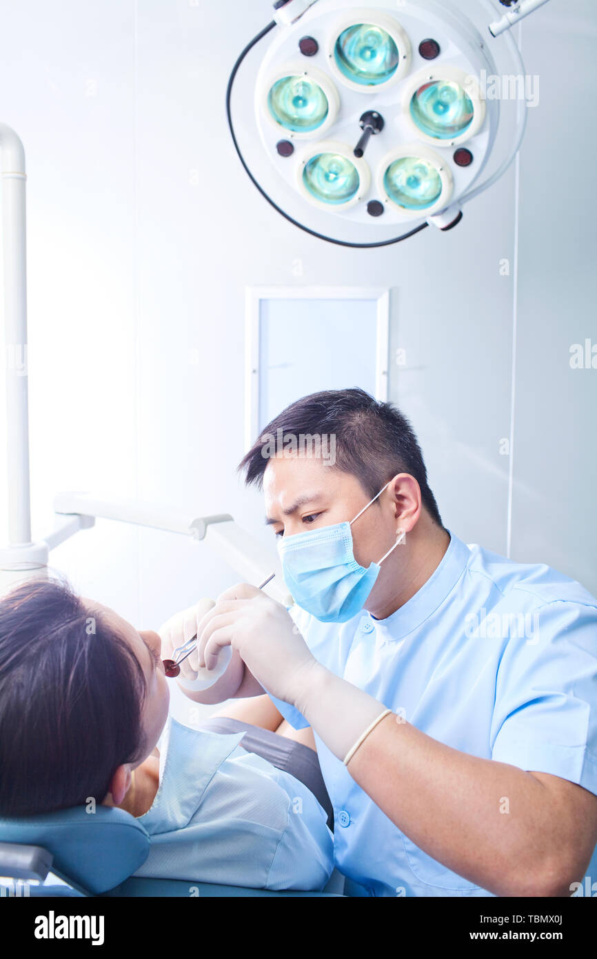Doctors treat teeth with patients in clinic Stock Photo - Alamy