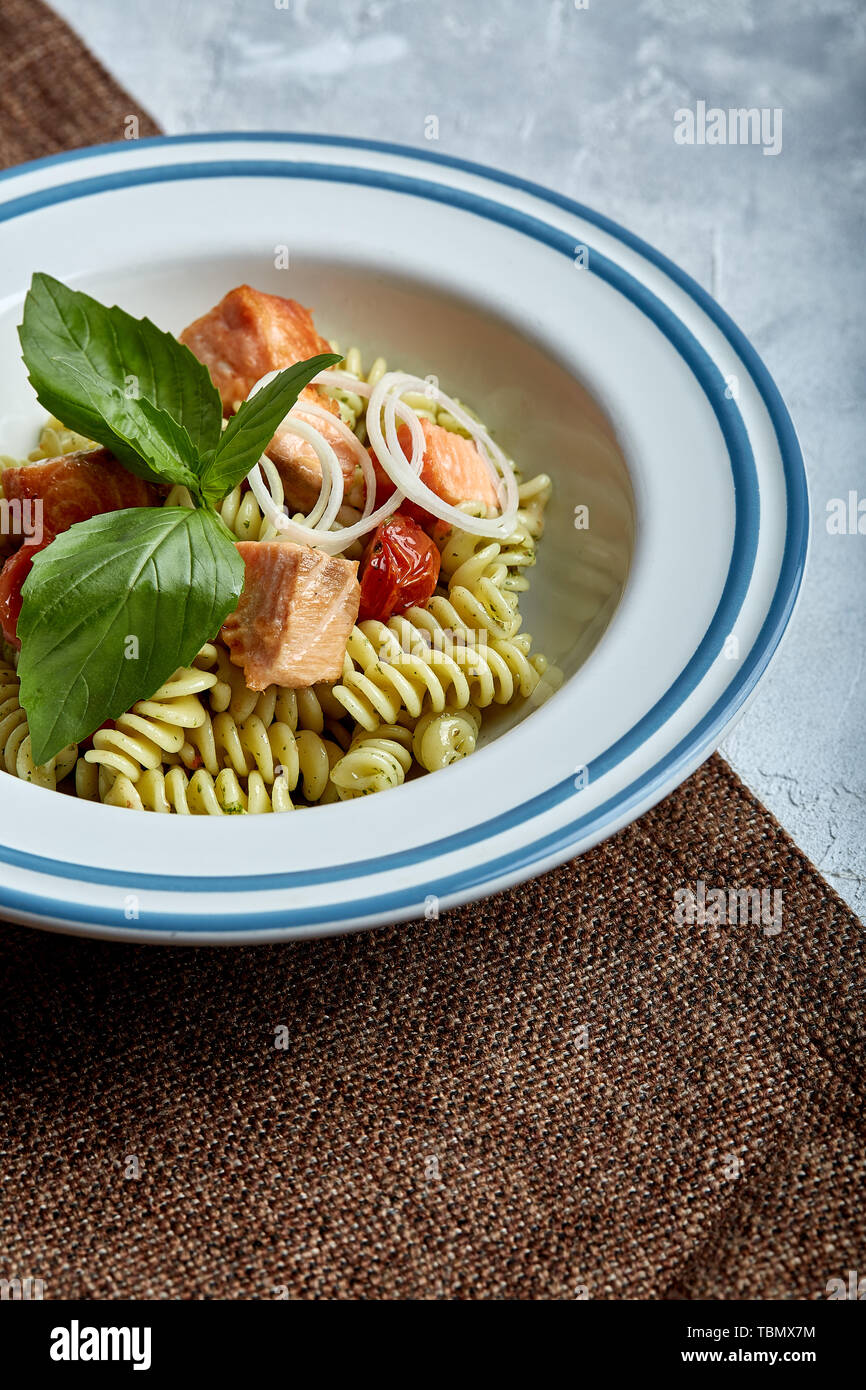 Fusilli pasta with baked salmon and spinach. The concept of Italian ...