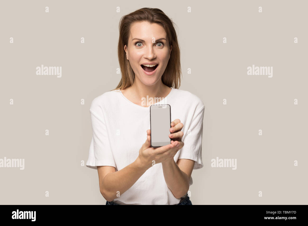 Mad young woman hold cellphone frustrated by phone malfunction Stock ...