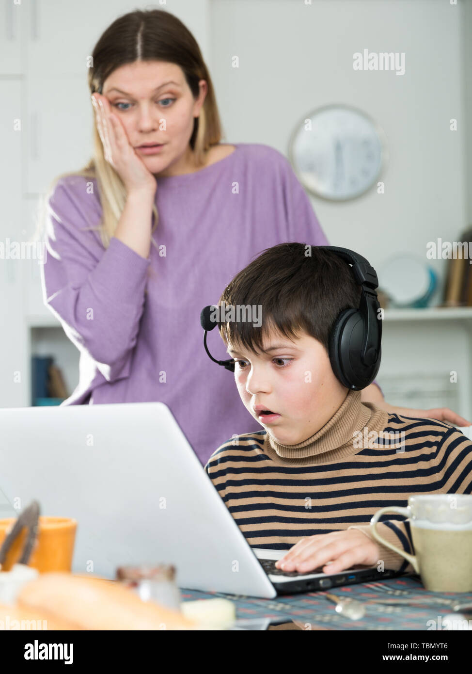 Upset mother arguing with son who plaing video games in domestic ...