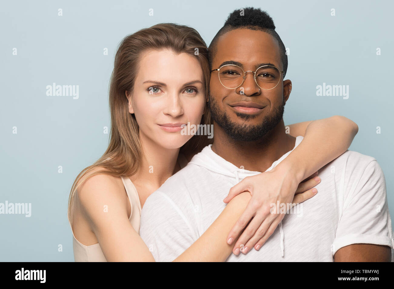 Happy multiracial couple look at camera posing together Stock Photo - Alamy