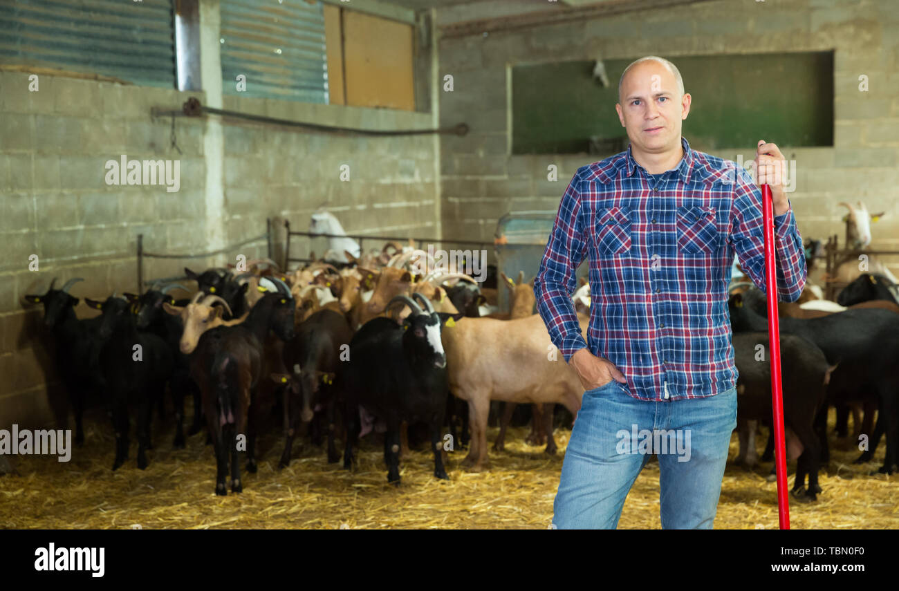 Male farmer holding agricultural tool Stock Photo - Alamy