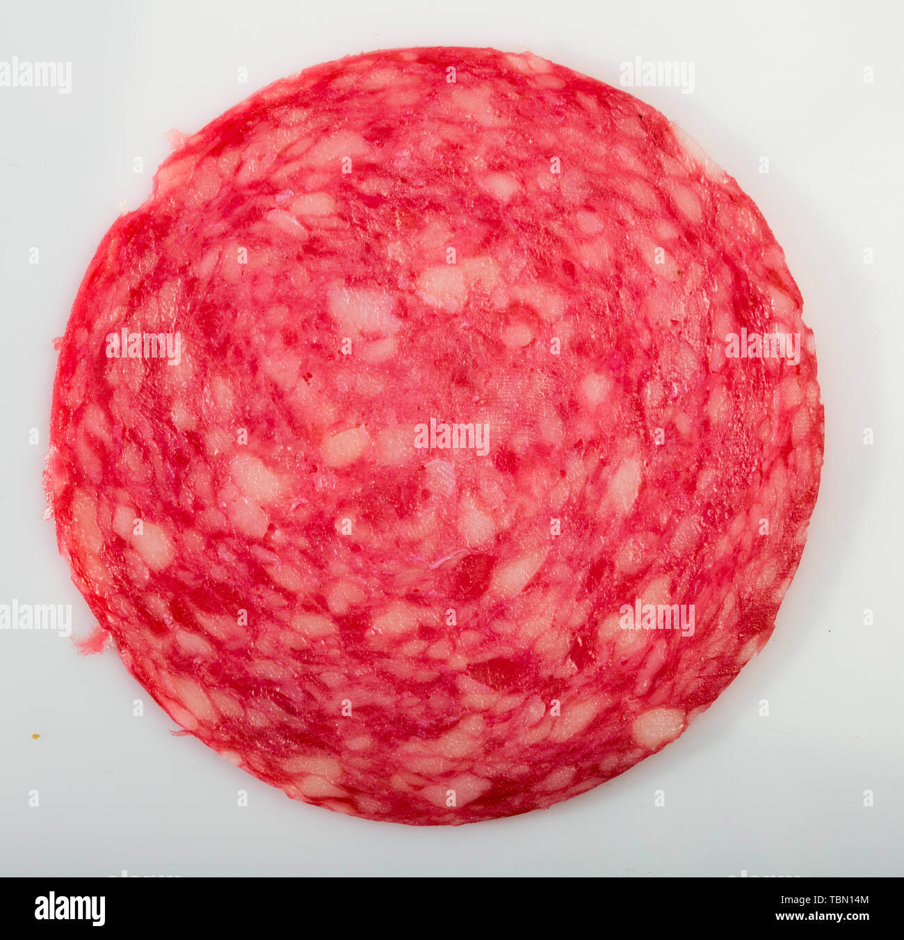 Top view of smoked salami sausage slices on white background Stock Photo - Alamy