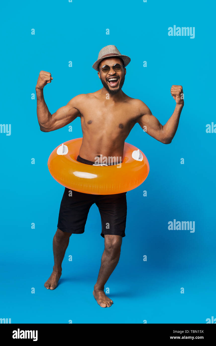 Happy black man in inflatable ring enjoying vacation Stock Photo - Alamy