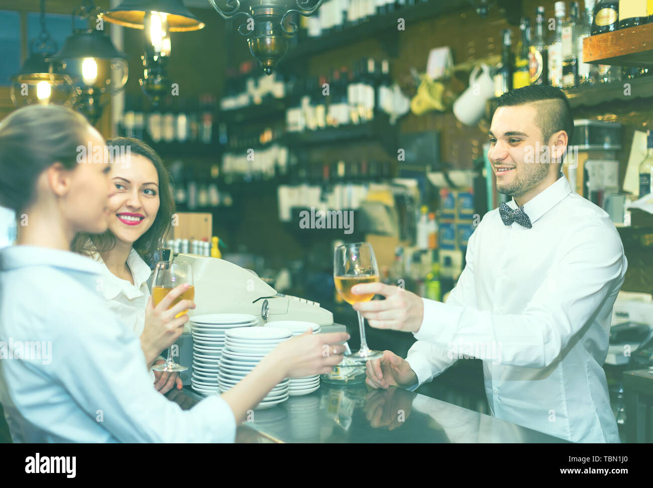 Two beautiful girls flirting handsome hi-res stock photography and ...