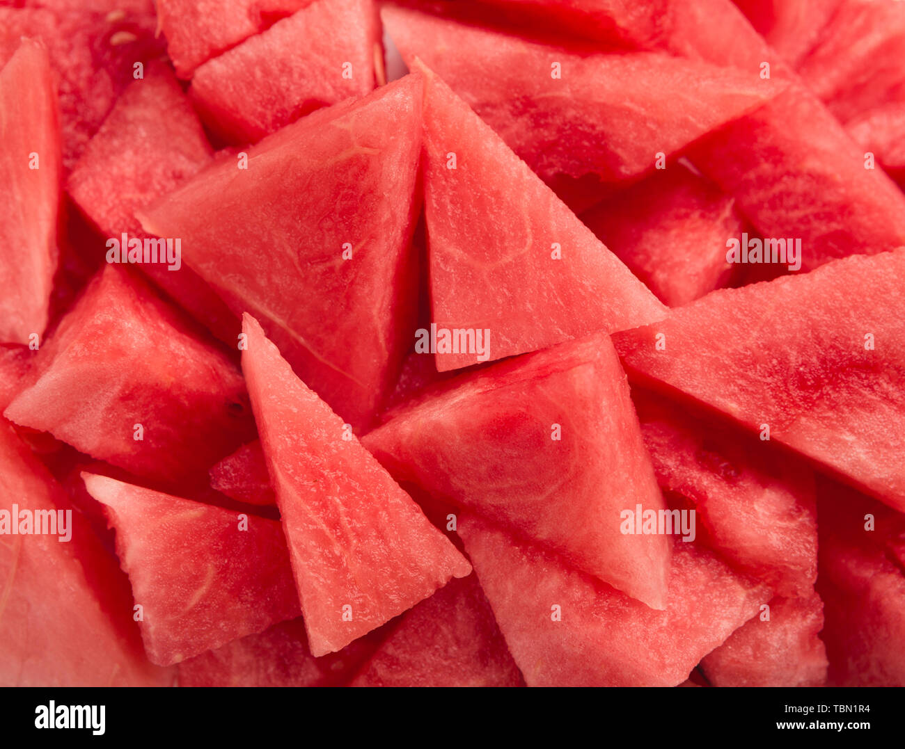 Red watermelon backdrop. Fresh triangle shaped pieces Stock Photo - Alamy