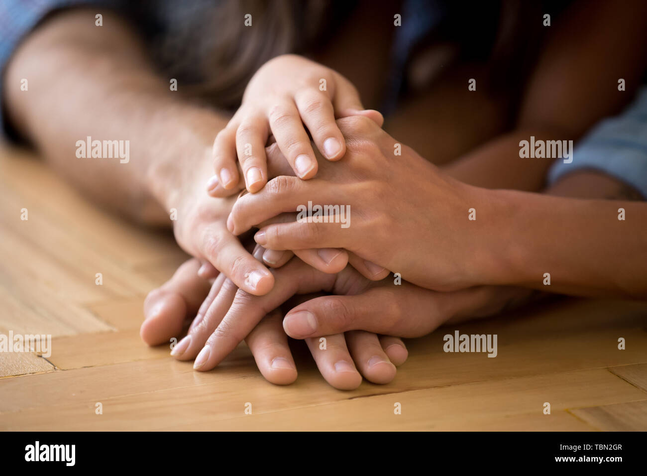 Close up of loving family stack hands showing unity Stock Photo - Alamy