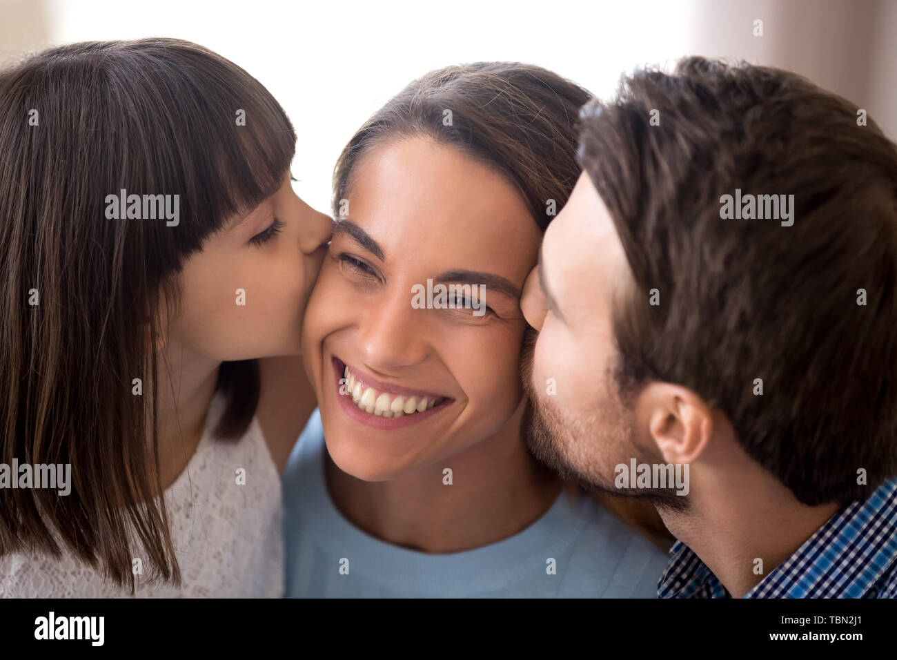 Loving dad and daughter kiss smiling mom on cheeks Stock Photo - Alamy Loving dad and daughter kiss smiling mom on cheeks Stock Photo - Alamy