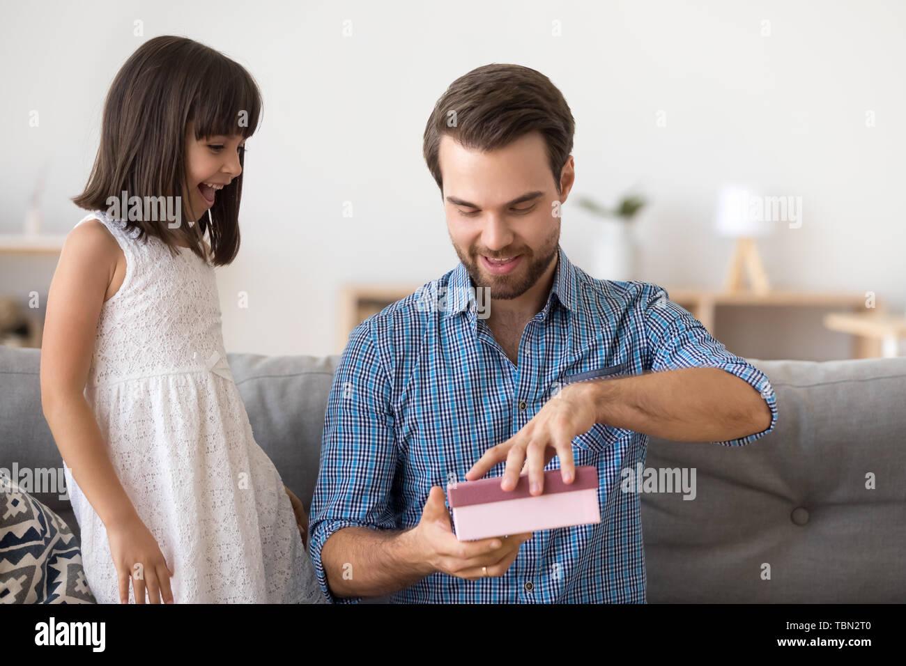 Excited dad open gift box from cute preschooler daughter Stock Photo ...
