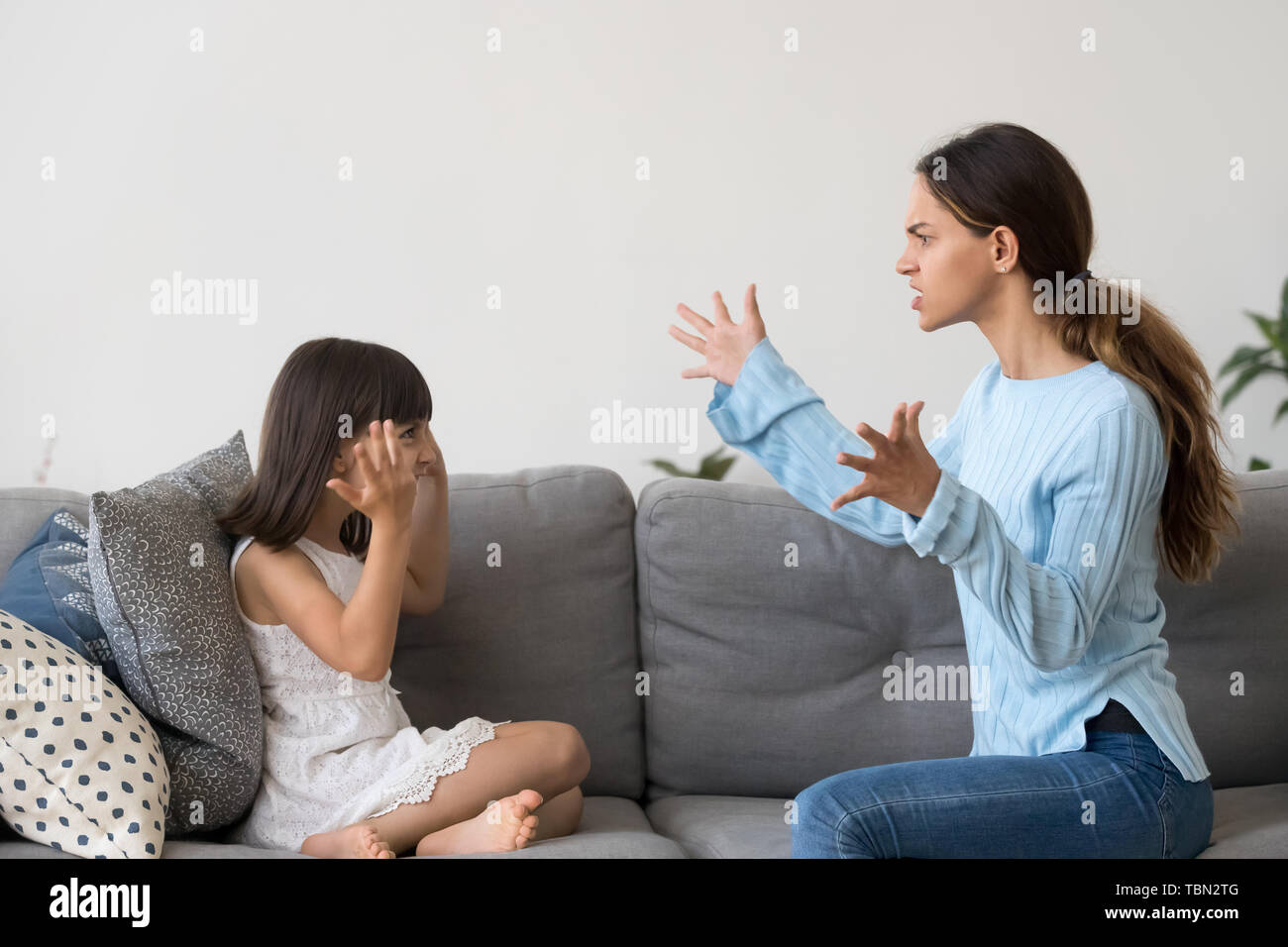Angry young mom gesture arguing with little kid Stock Photo - Alamy