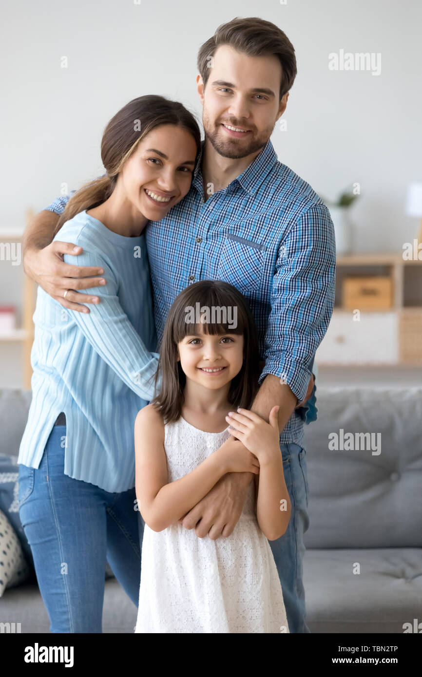 Family portrait of loving parents hug posing with little daughter Stock ...