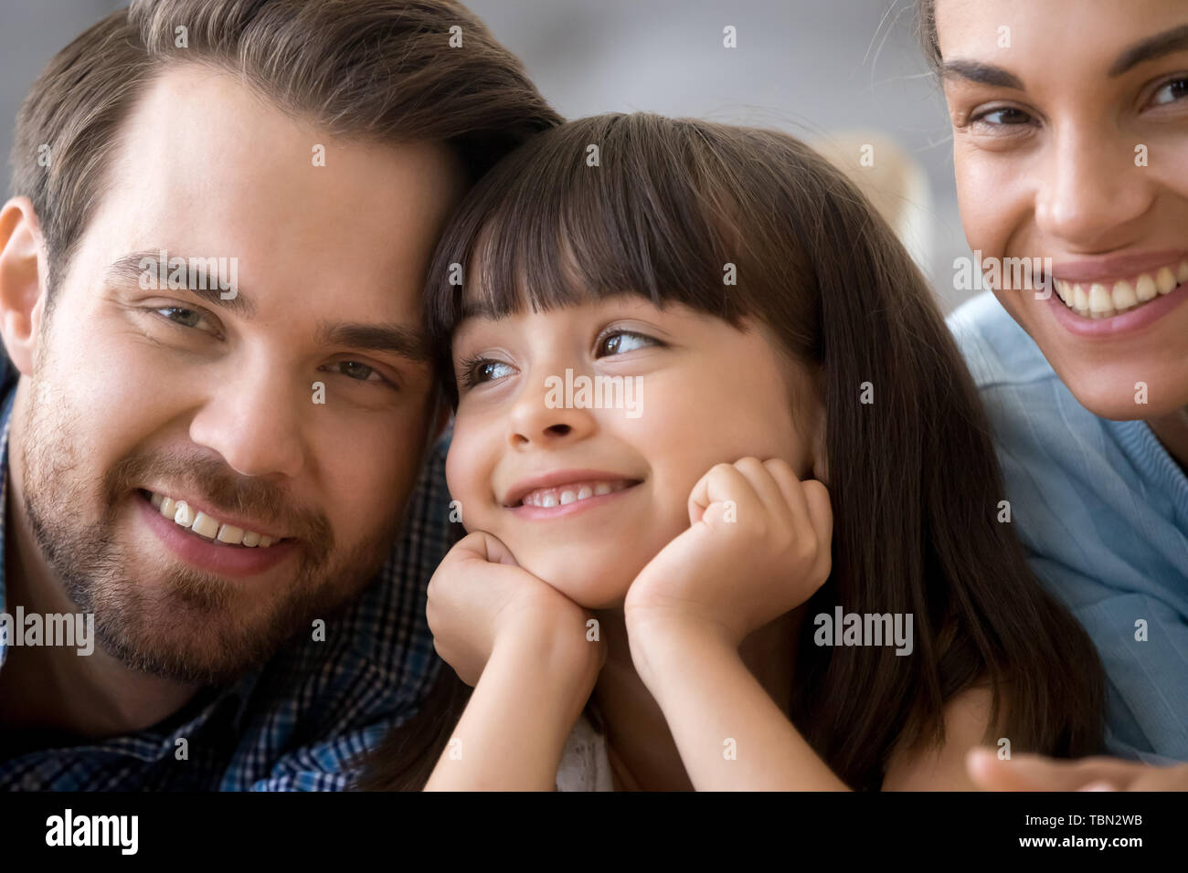 Happy parents posing for family picture with daughter Stock Photo - Alamy
