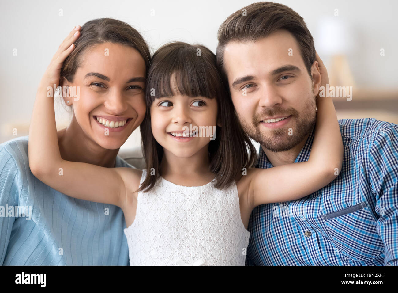 Family portrait of family with small kid hug posing Stock Photo - Alamy