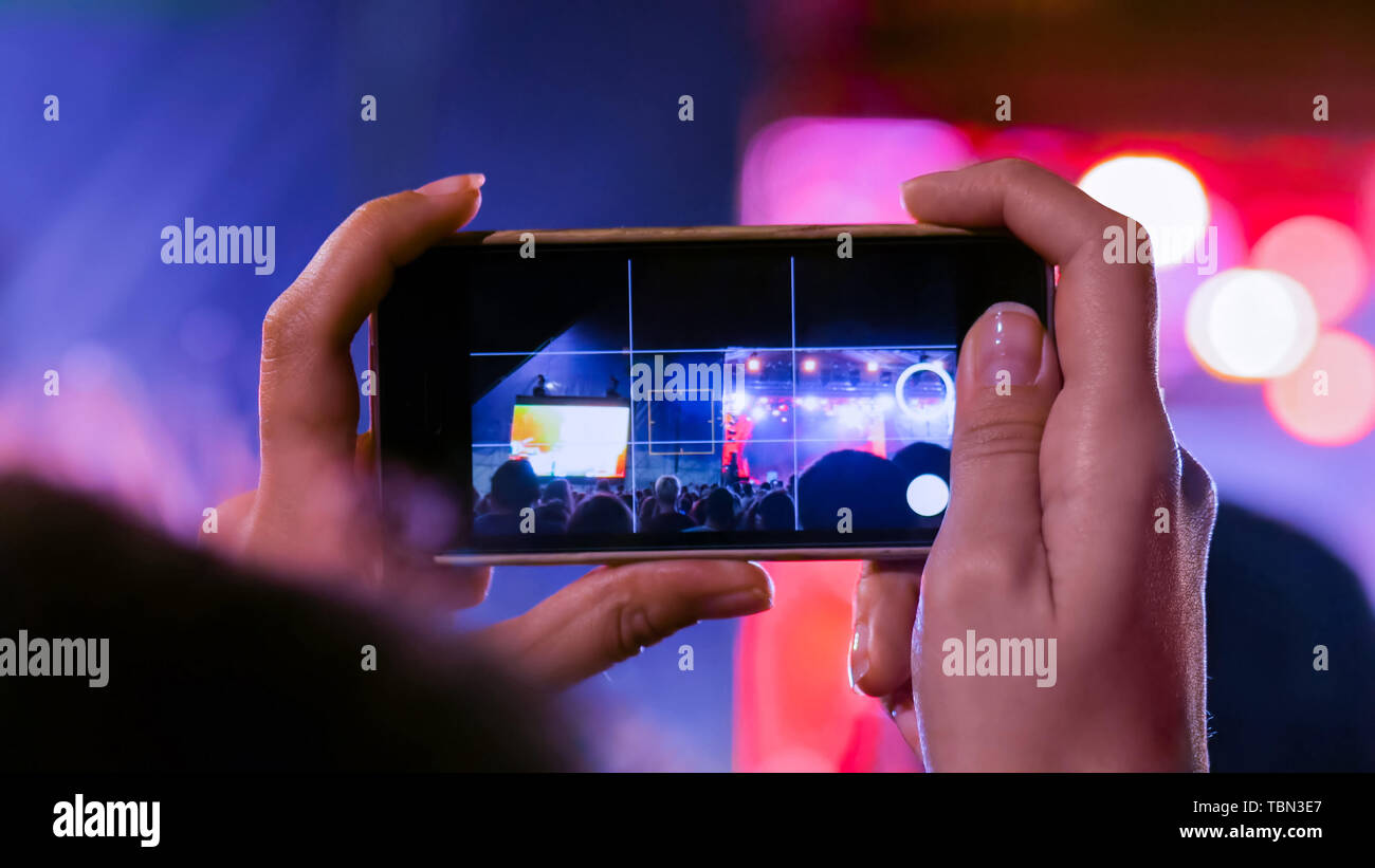Woman hands silhouette recording video of live music concert with ...