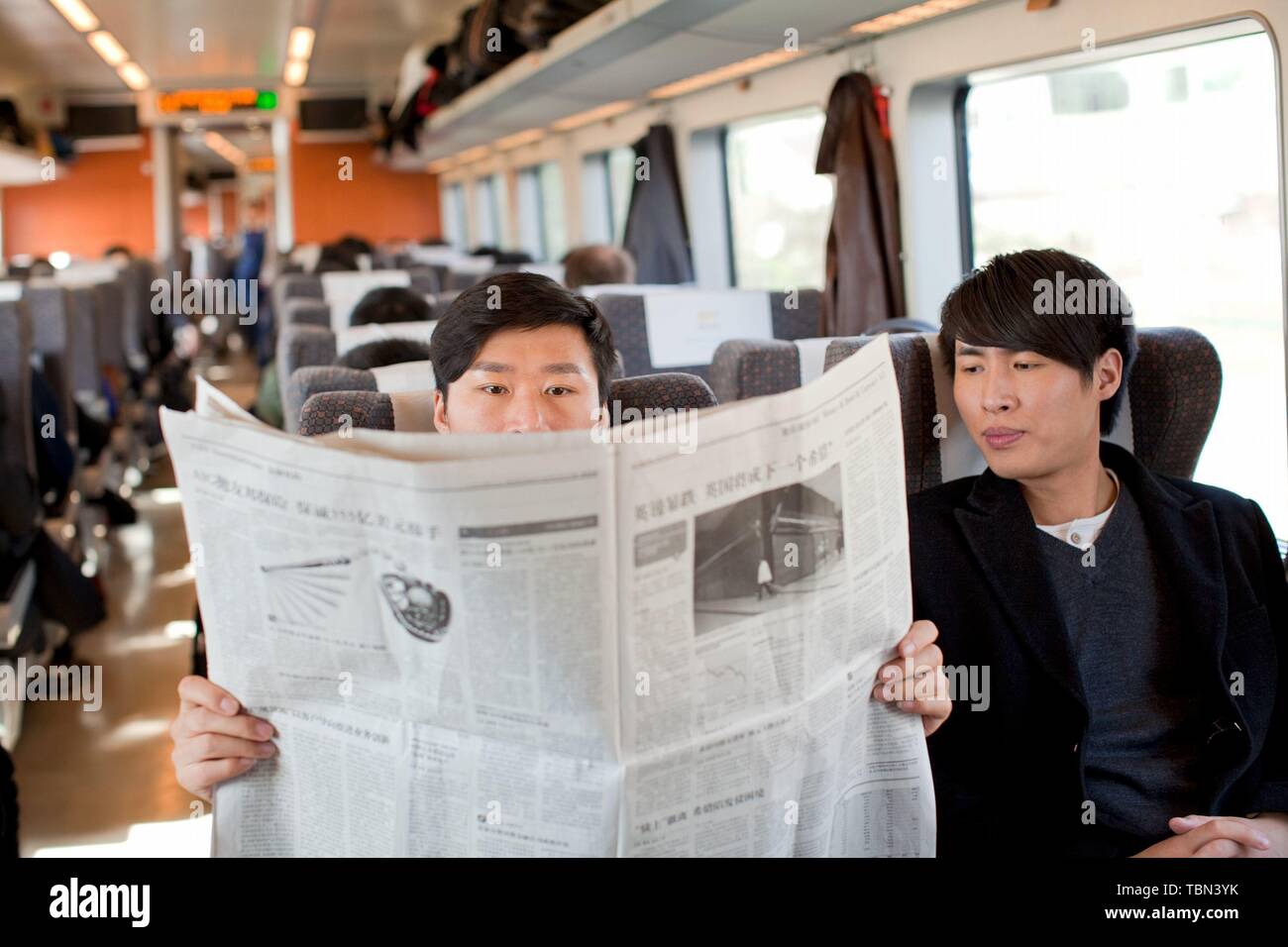 Asian man newspaper train hi-res stock photography and images - Alamy