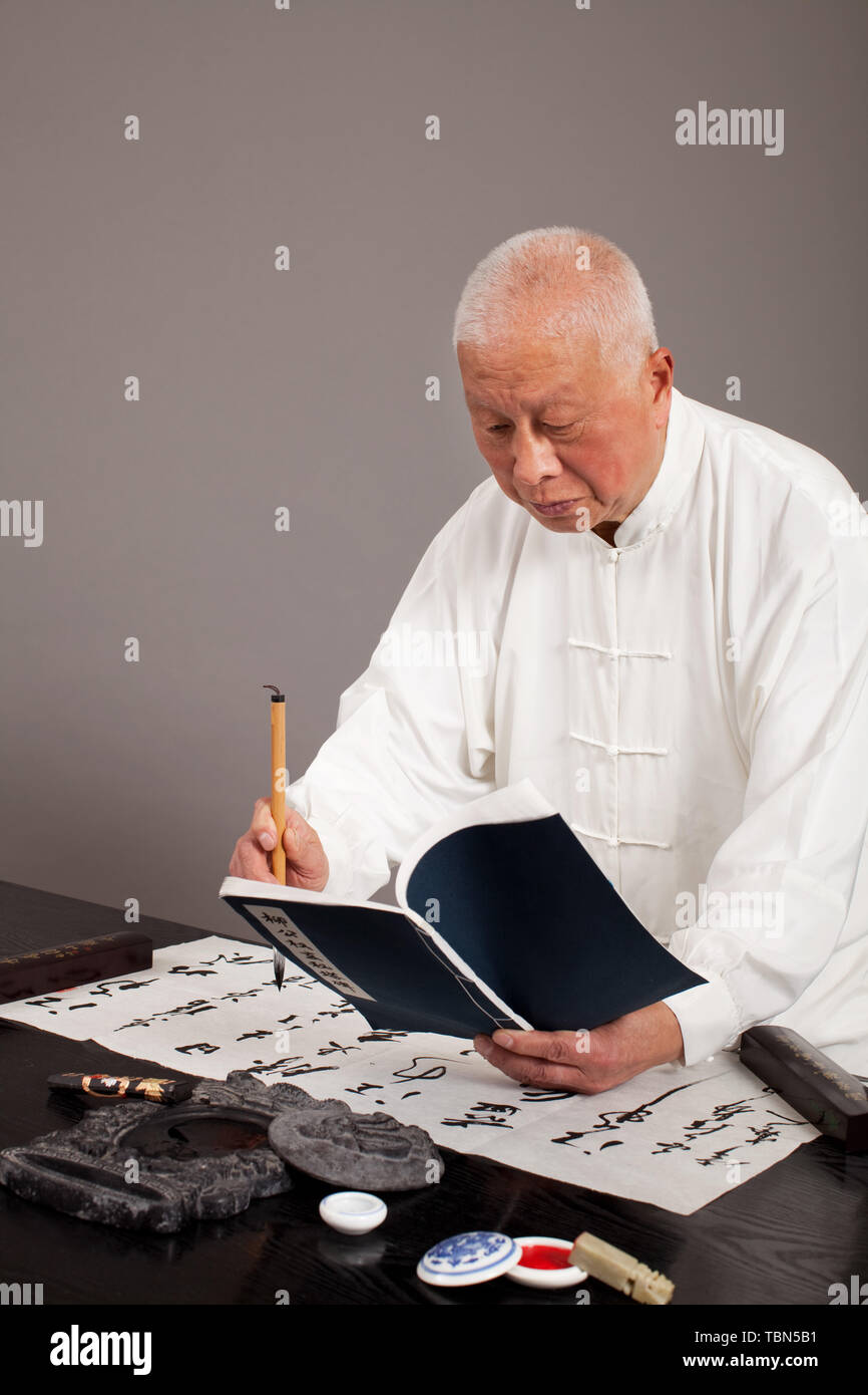 An old man practicing calligraphy Stock Photo - Alamy