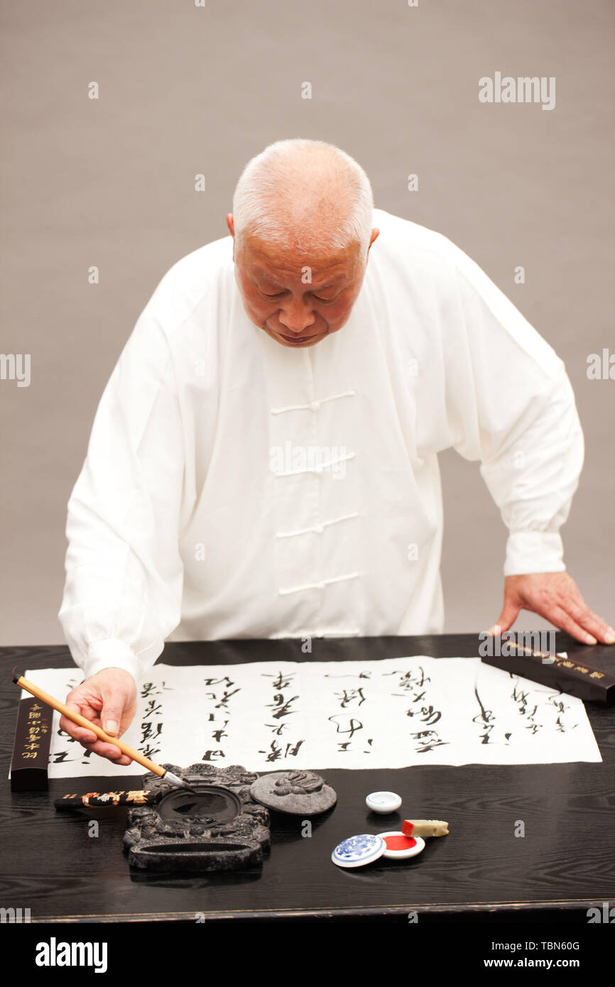 An old man practicing calligraphy Stock Photo - Alamy