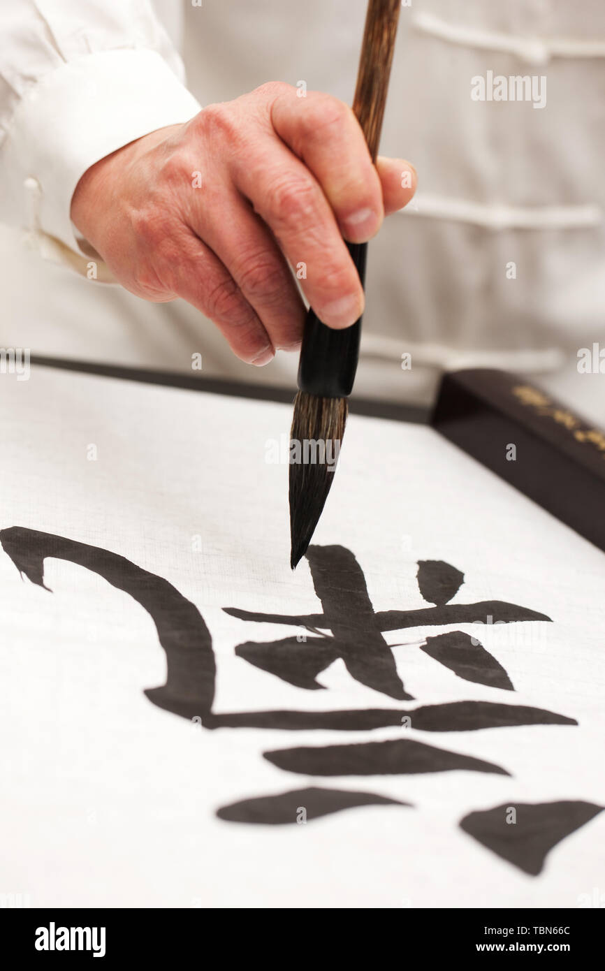 An old man practicing calligraphy Stock Photo - Alamy
