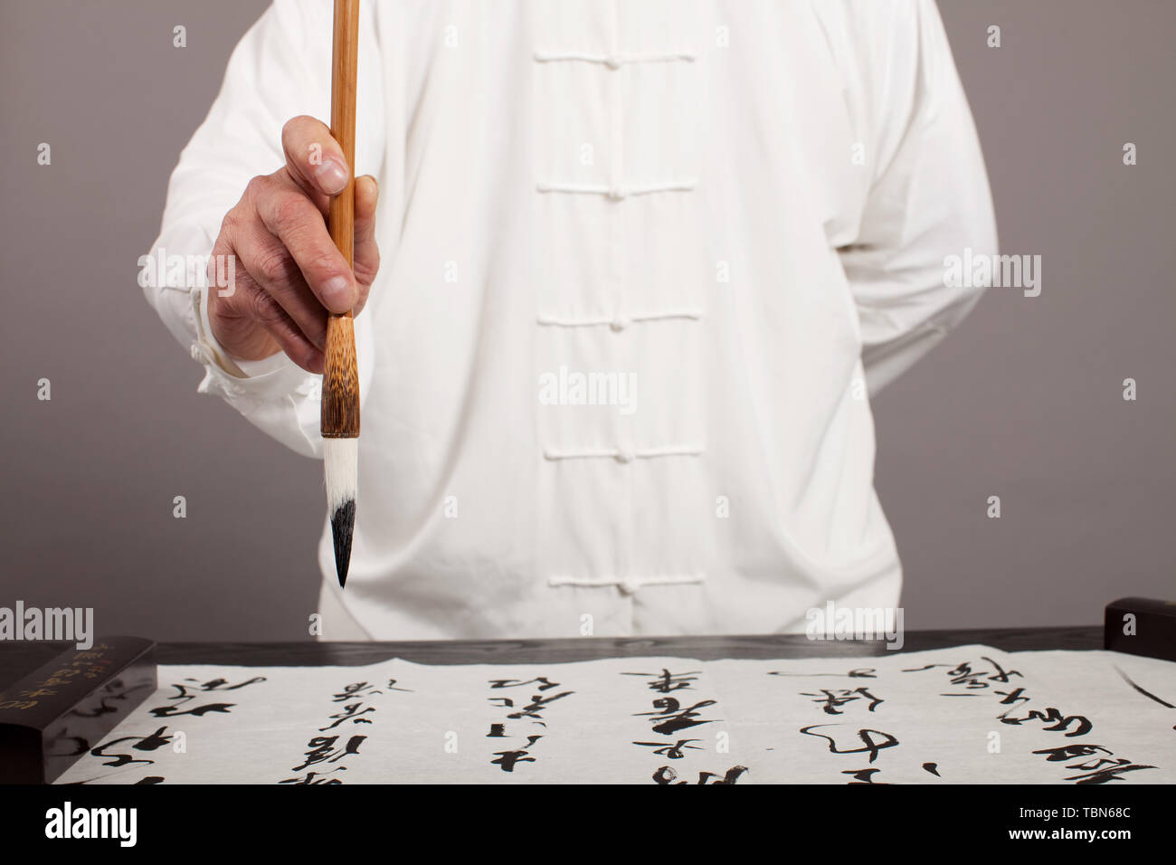 An old man practicing calligraphy Stock Photo - Alamy