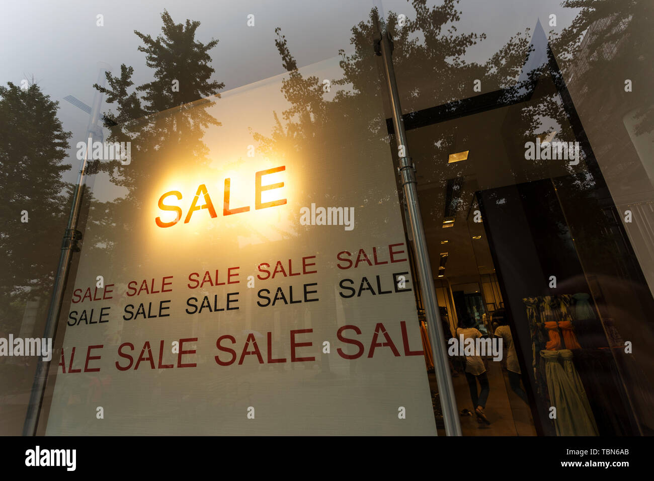 sale poster in the displaywindow of shop Stock Photo - Alamy