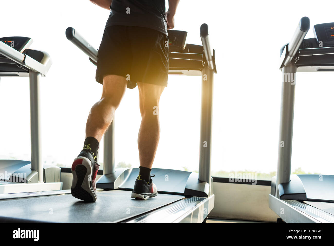 Legs of sportsman running on treadmill in fitness gym center. Sport and ...