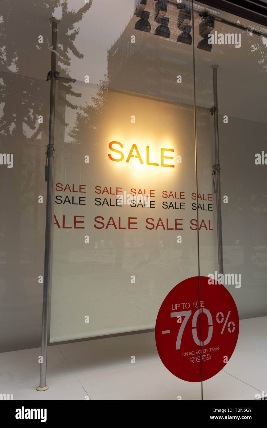 sale poster in the displaywindow of shop Stock Photo - Alamy
