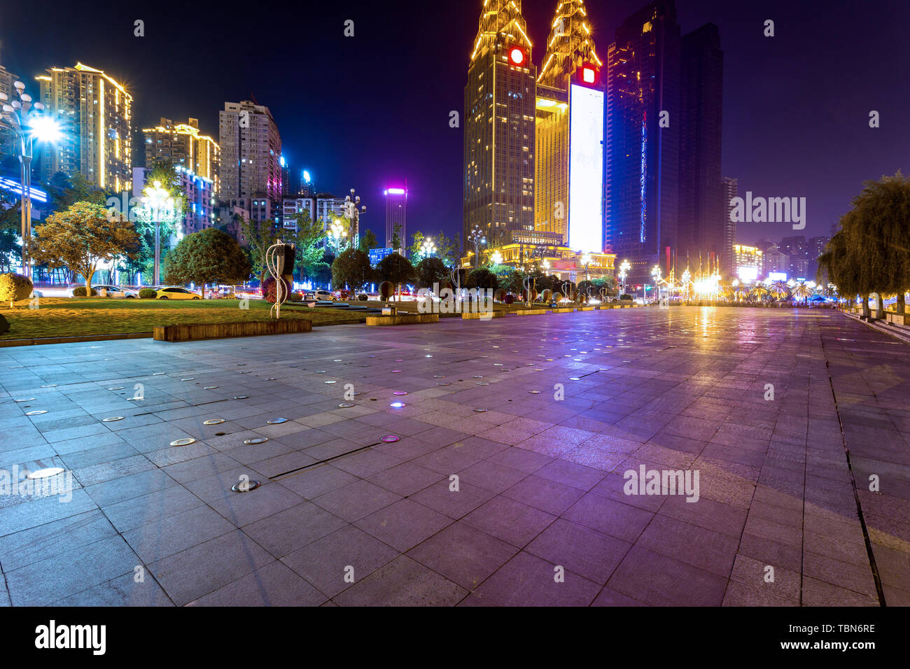 Empty floor and illuminated skyscraper Stock Photo - Alamy