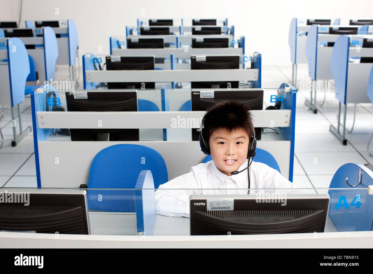 Three primary school students are in class in the classroom Stock Photo ...