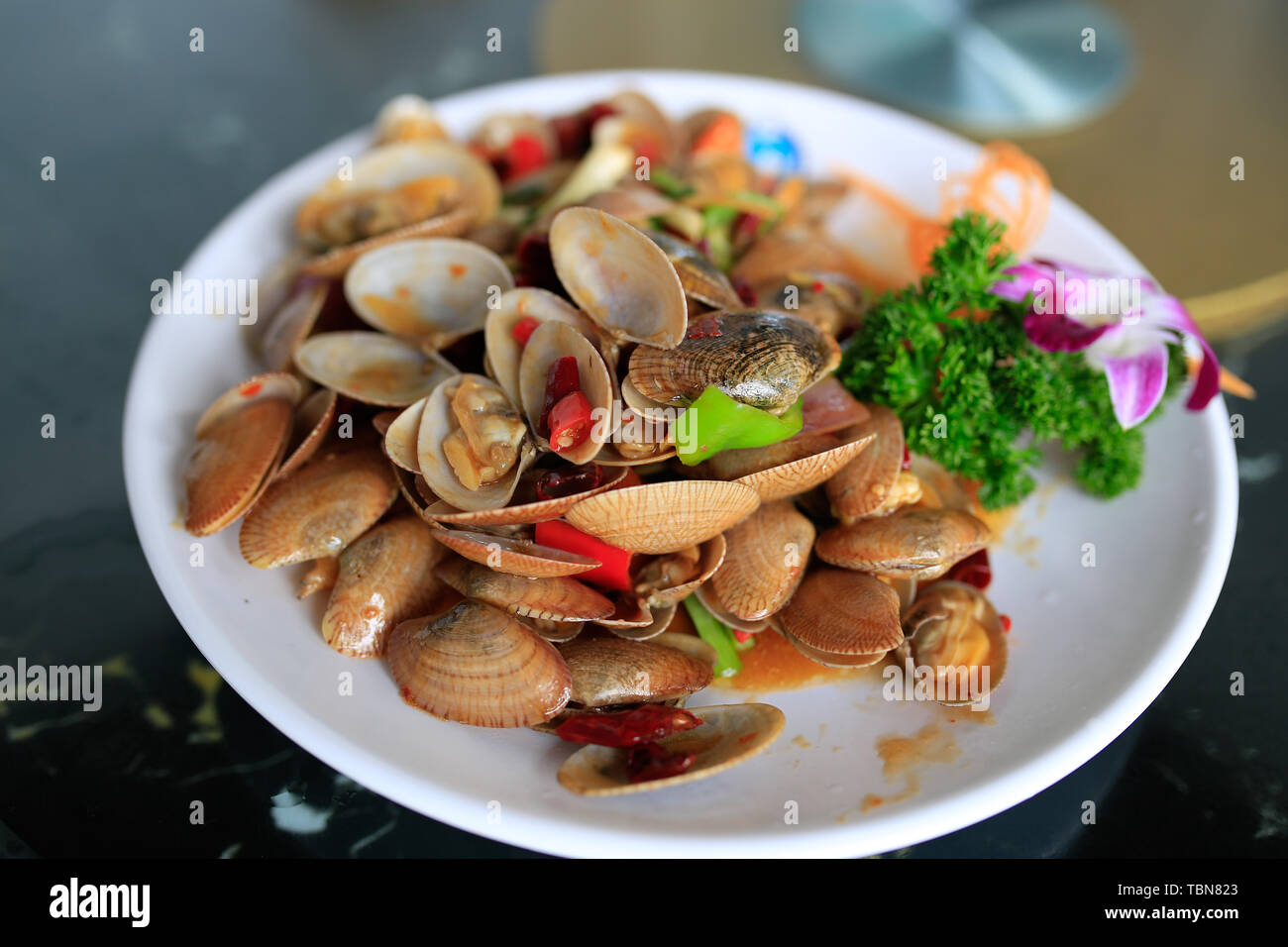 Stir-fried mango snail Stock Photo - Alamy