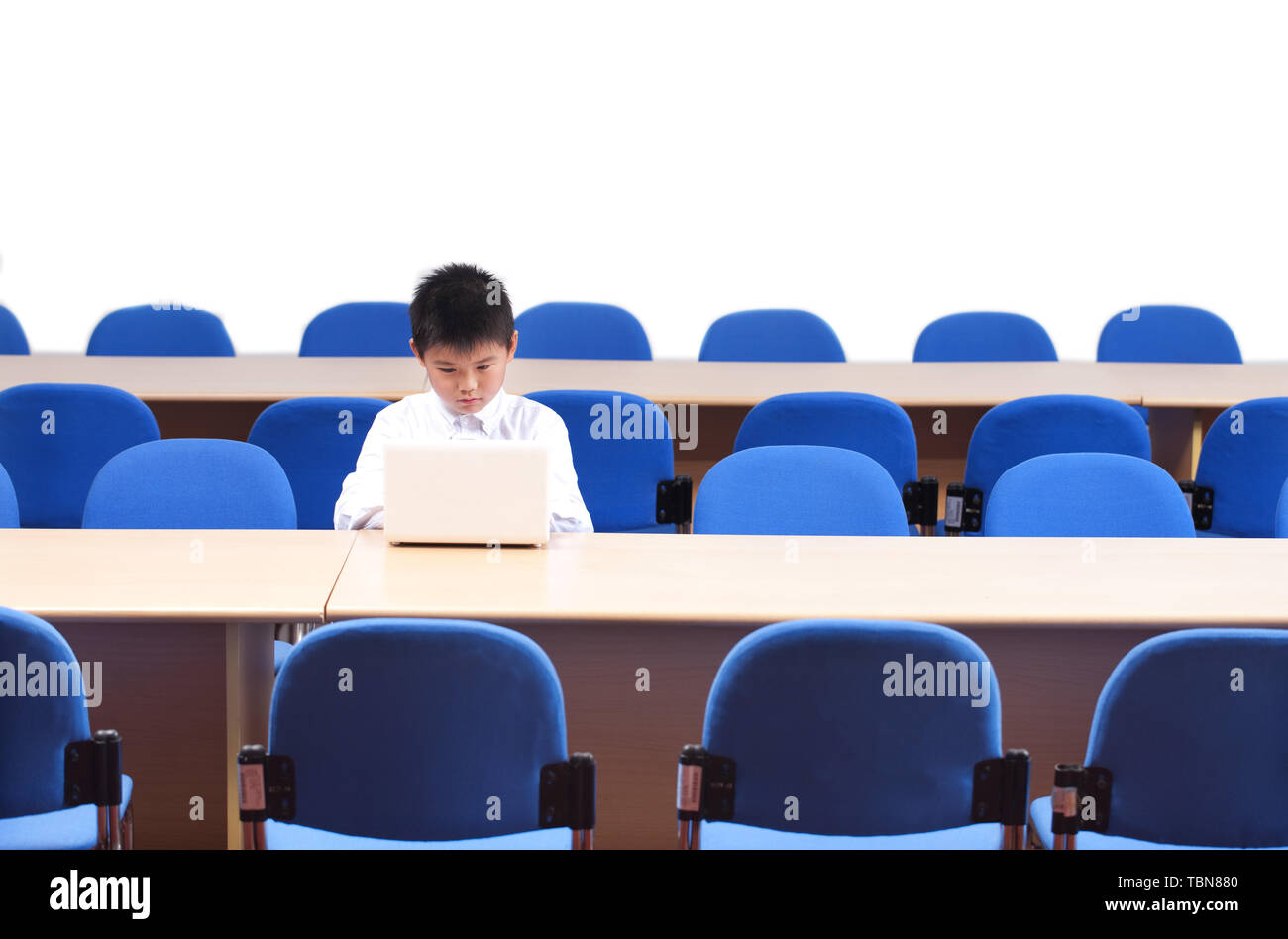 Three primary school students are in class in the classroom Stock Photo ...