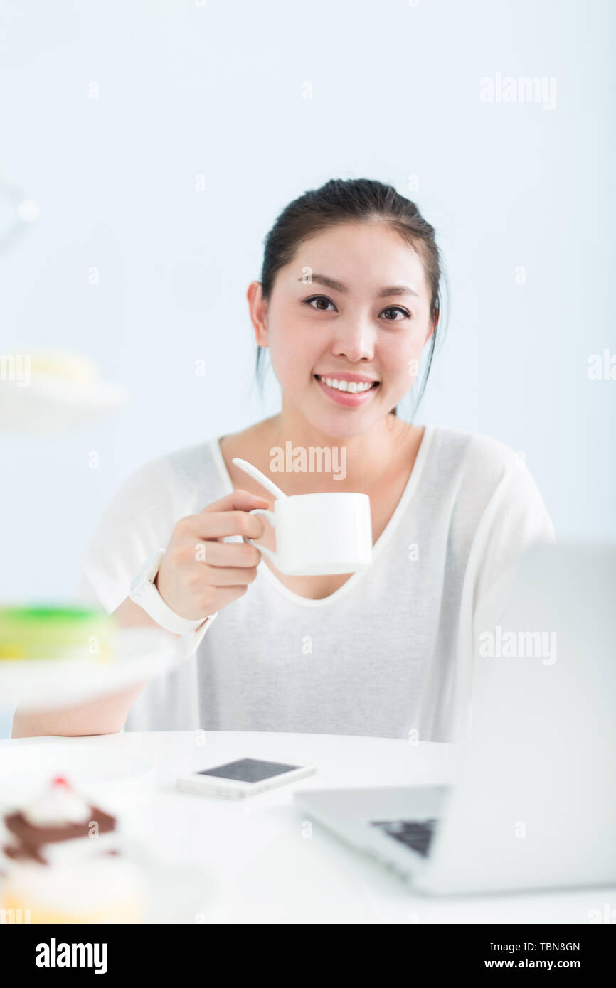 young pretty chinese woman working with laptop in office Stock Photo ...