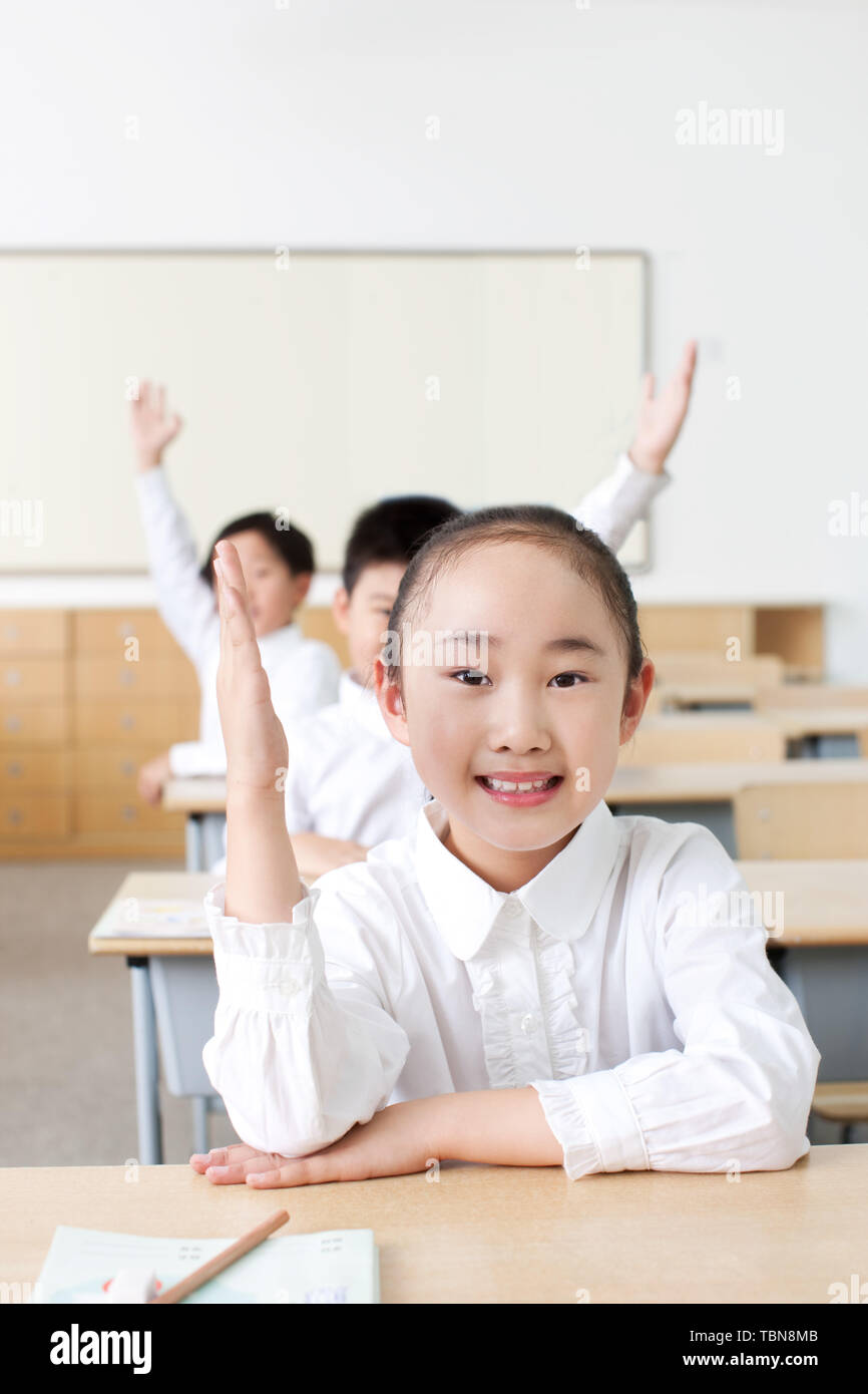 Three primary school students are in class in the classroom Stock Photo ...