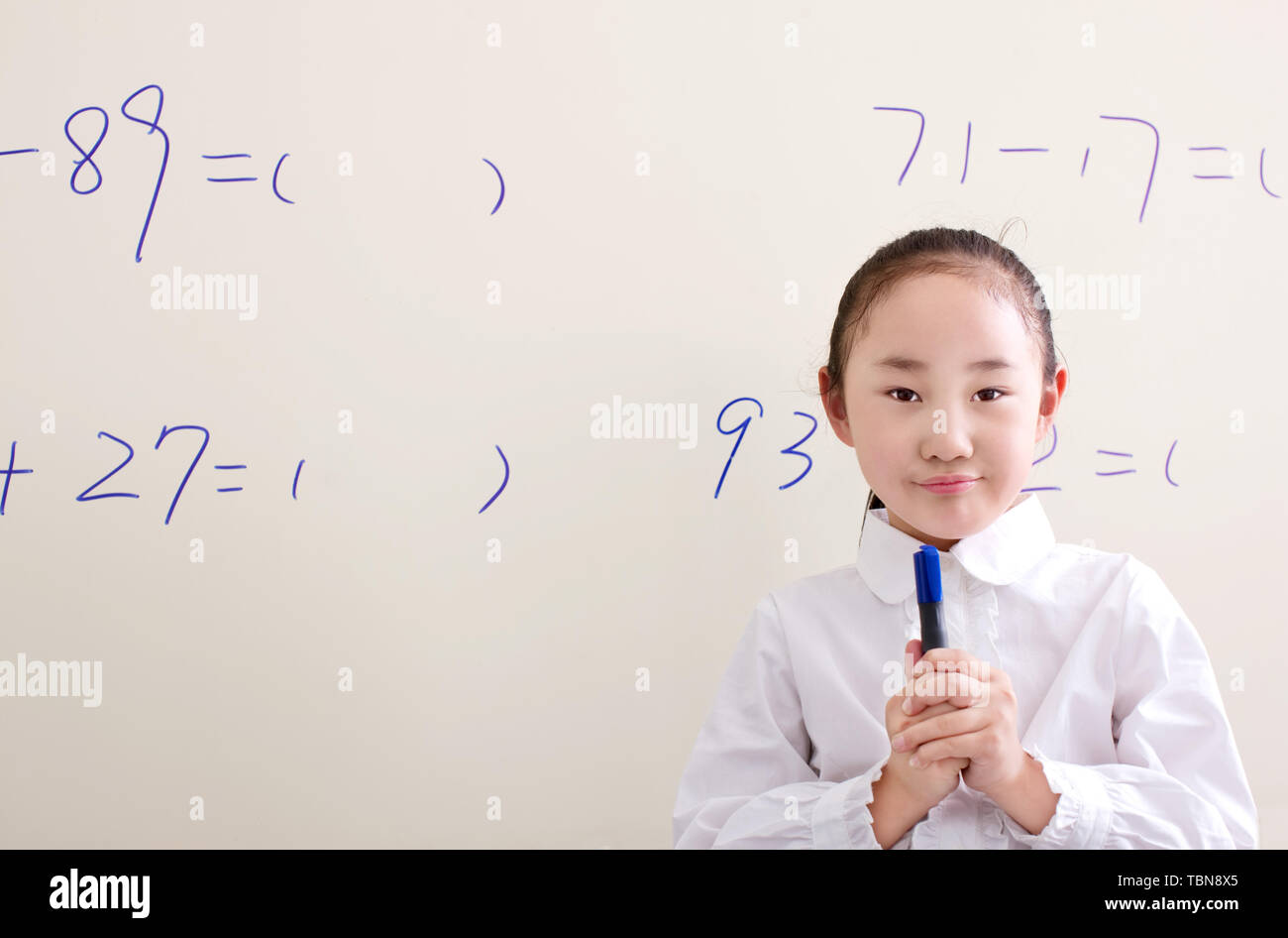 Three primary school students are in class in the classroom Stock Photo ...