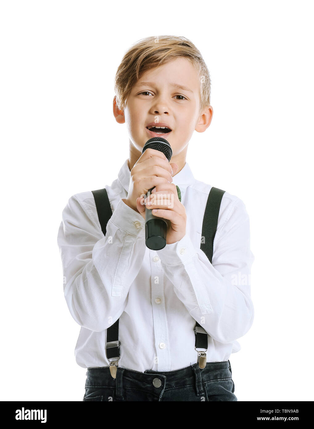 Cute little boy with microphone singing against white background Stock ...