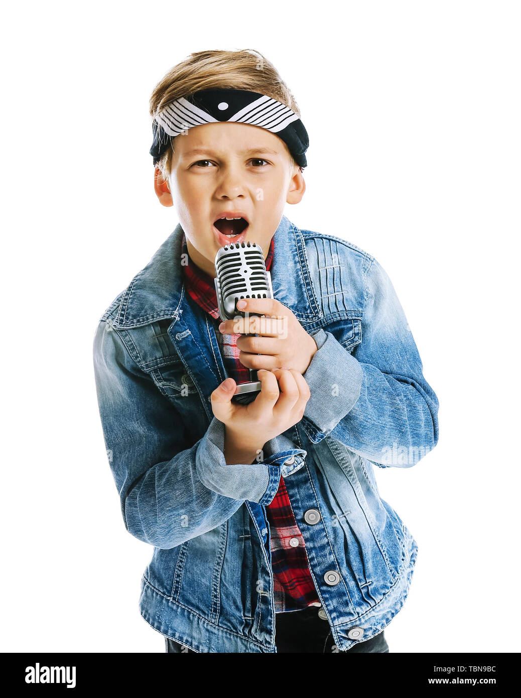 Cute little boy with microphone singing against white background Stock ...