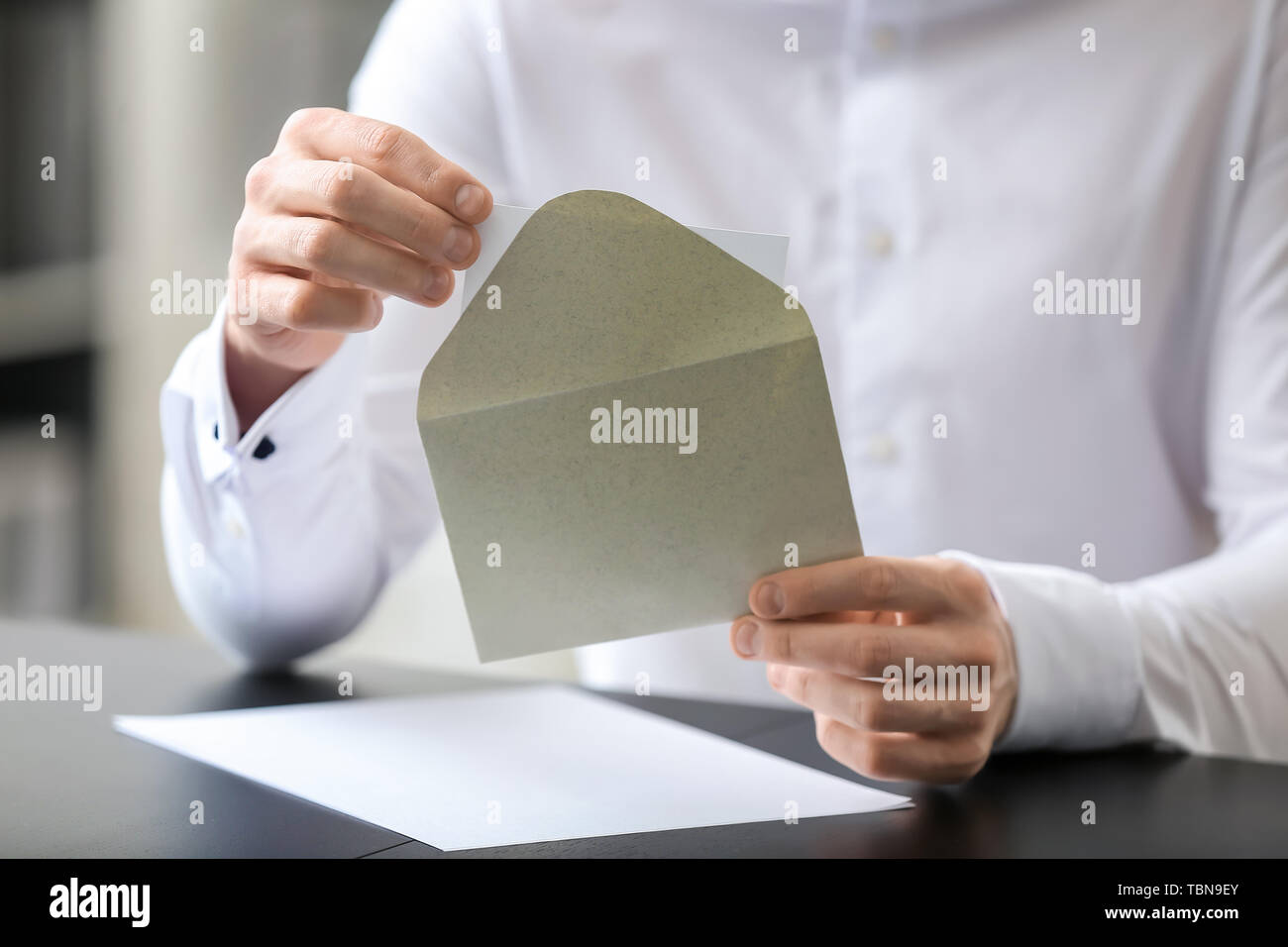 Young man receiving invitation Stock Photo - Alamy