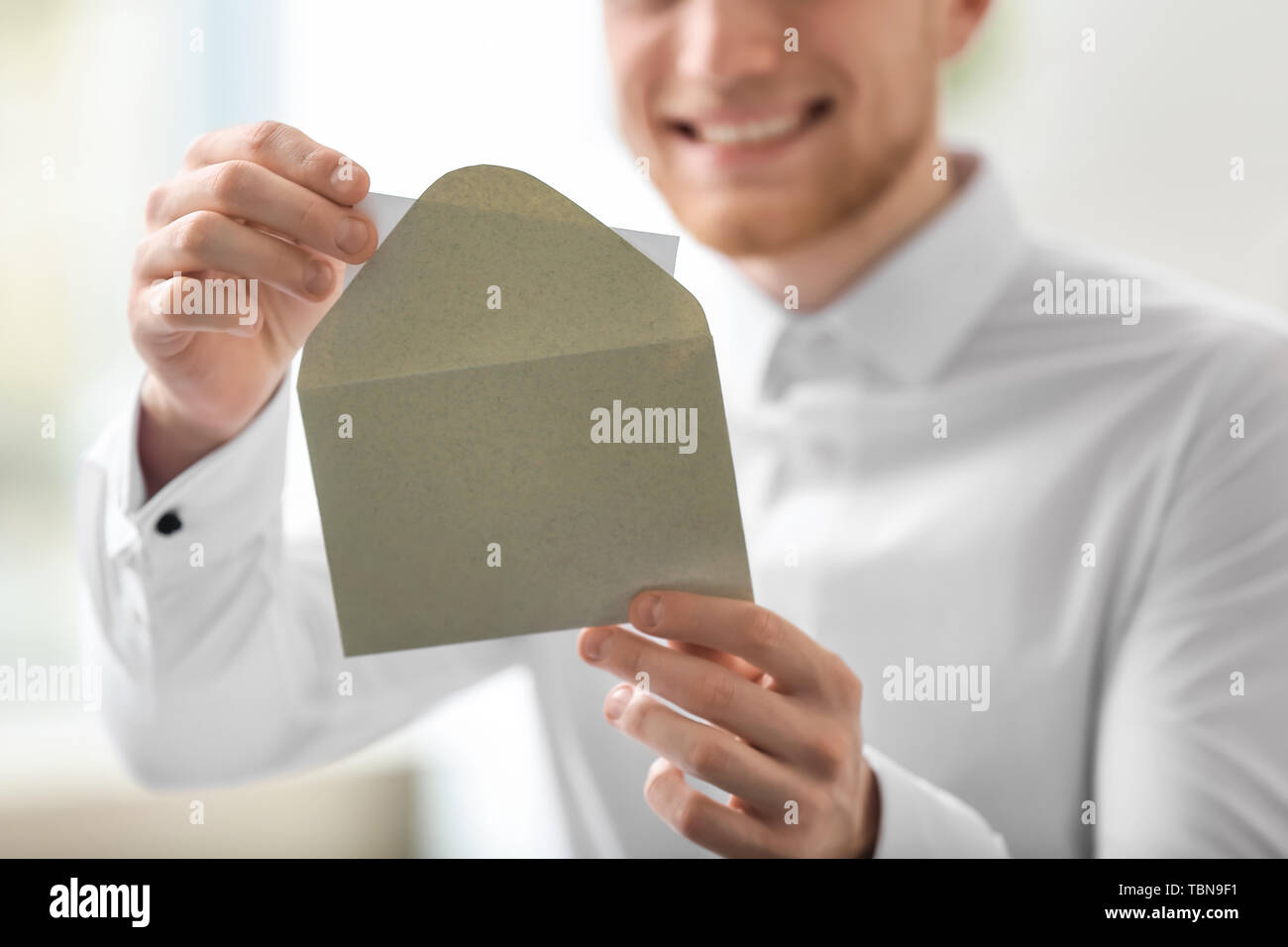 Young man receiving invitation Stock Photo - Alamy