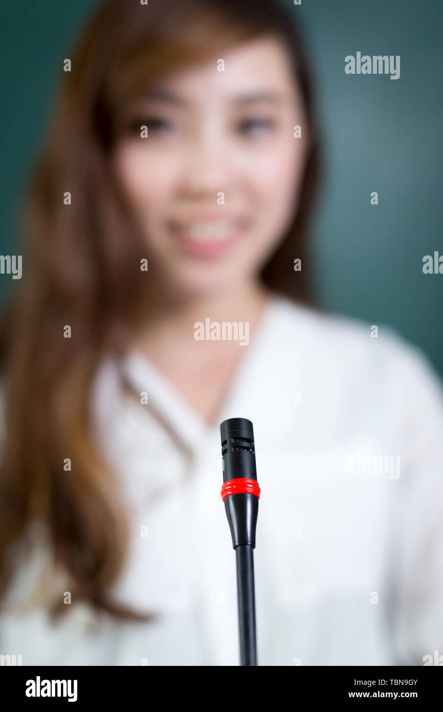 Asian beautiful woman speaking in front of blackboard with micro Stock ...