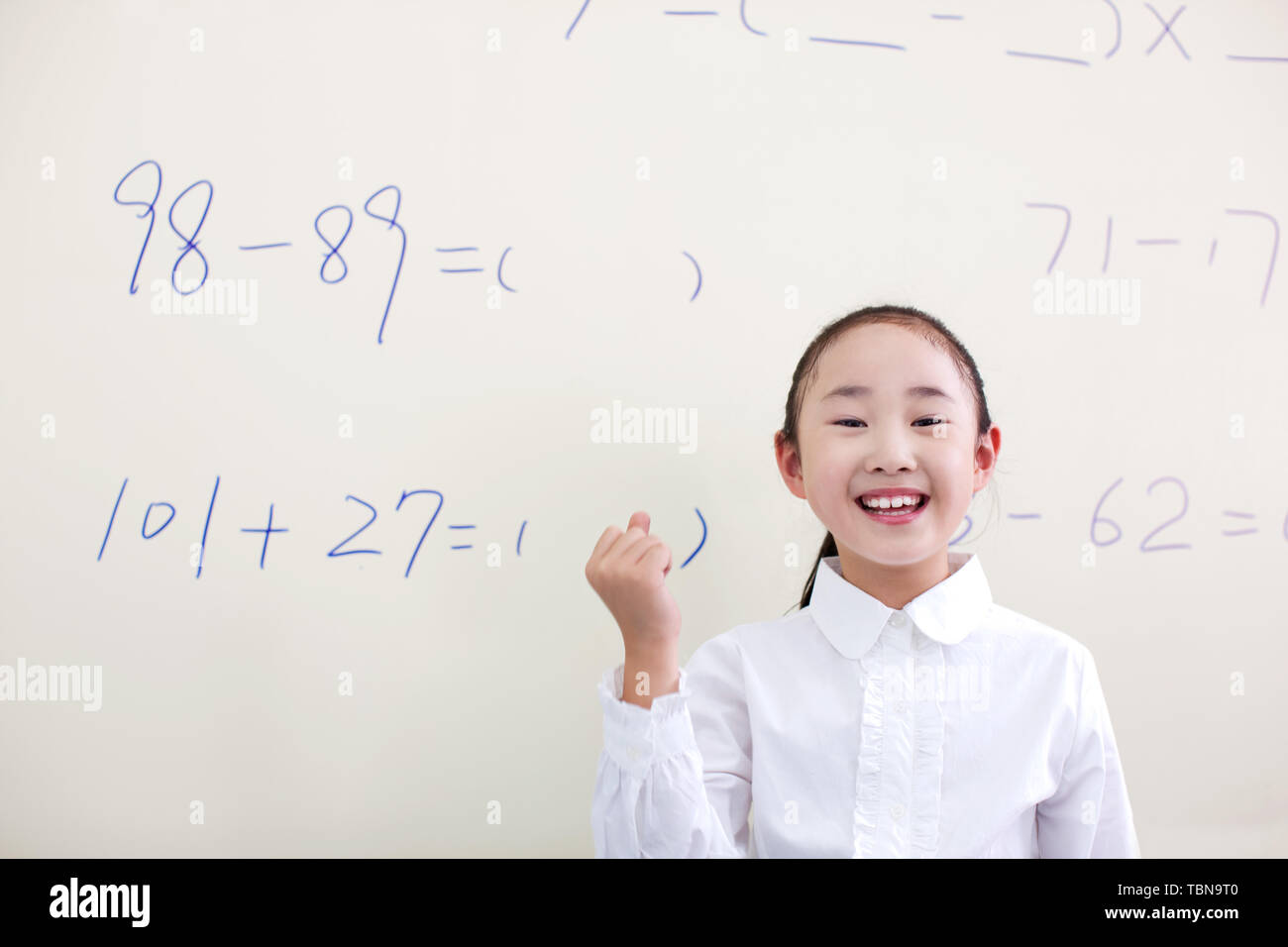 Three primary school students are in class in the classroom Stock Photo ...