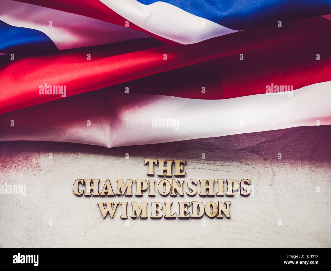 WIMBLEDON. Wooden, unpainted letters on a white table. Close-up, top ...