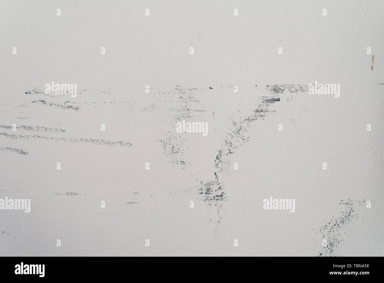 white shabby wall. old shabby background. detached paint on the wall ...