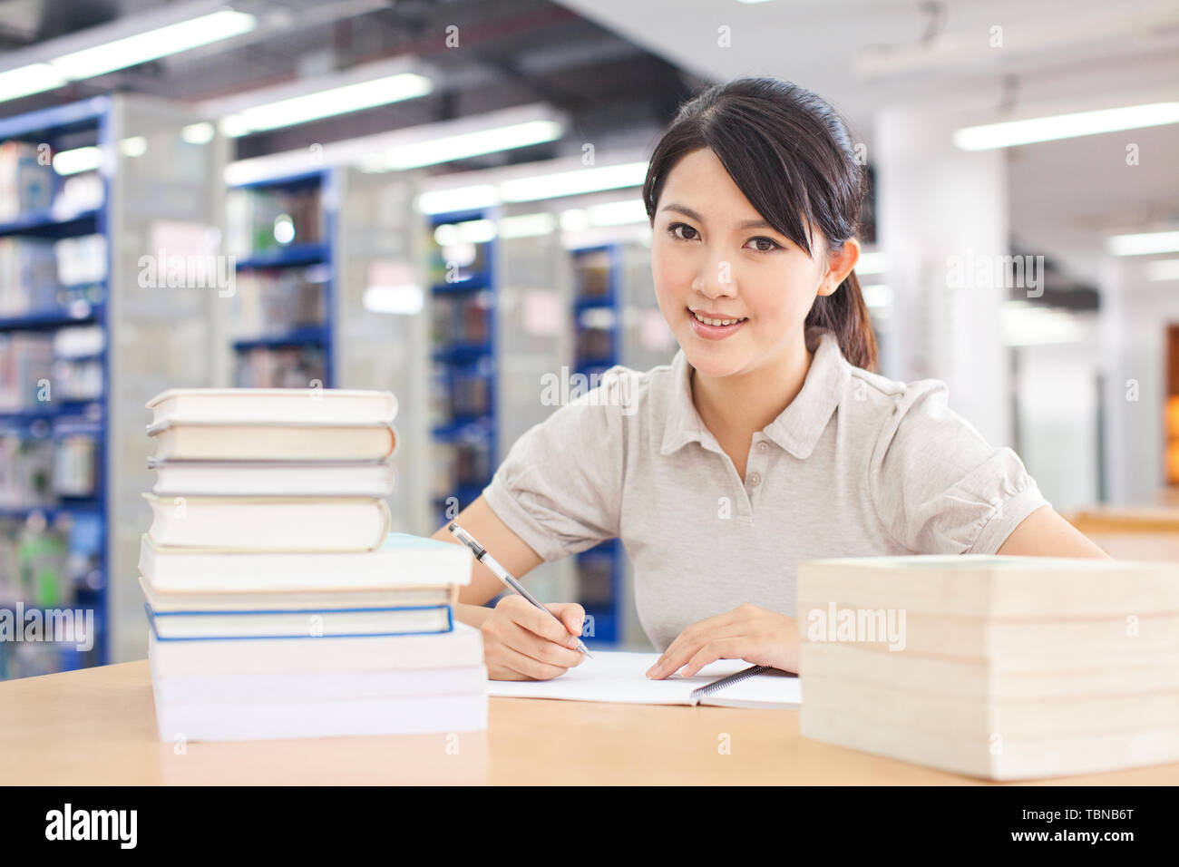 Studying in the library Stock Photo - Alamy