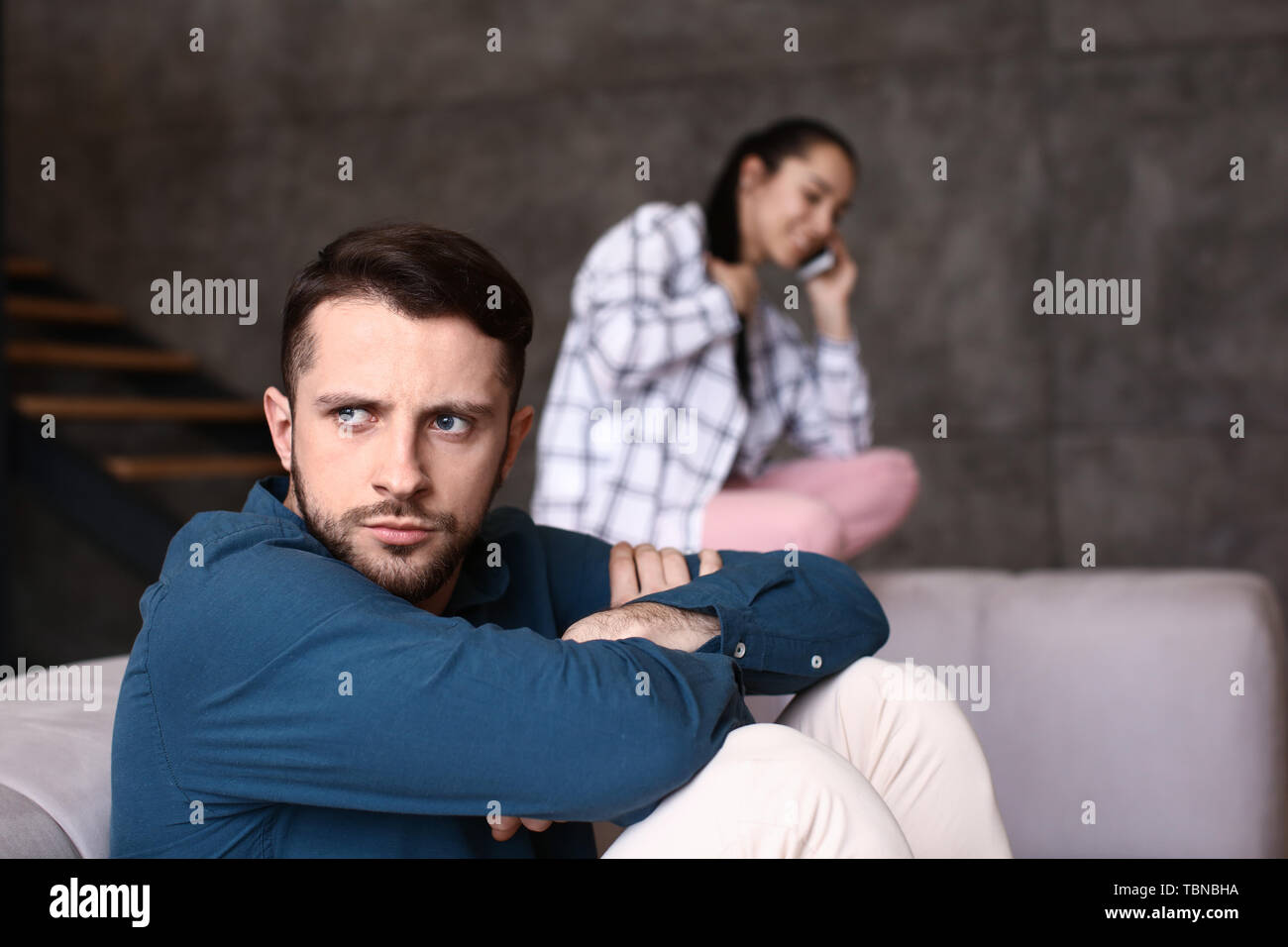 Offended husband angry with his wife at home Stock Photo - Alamy