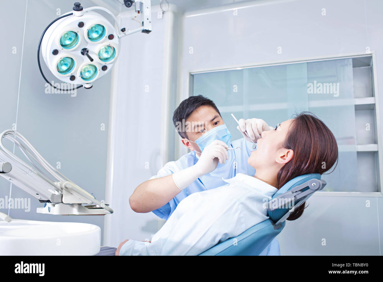 Doctors treat teeth with patients in clinic Stock Photo - Alamy